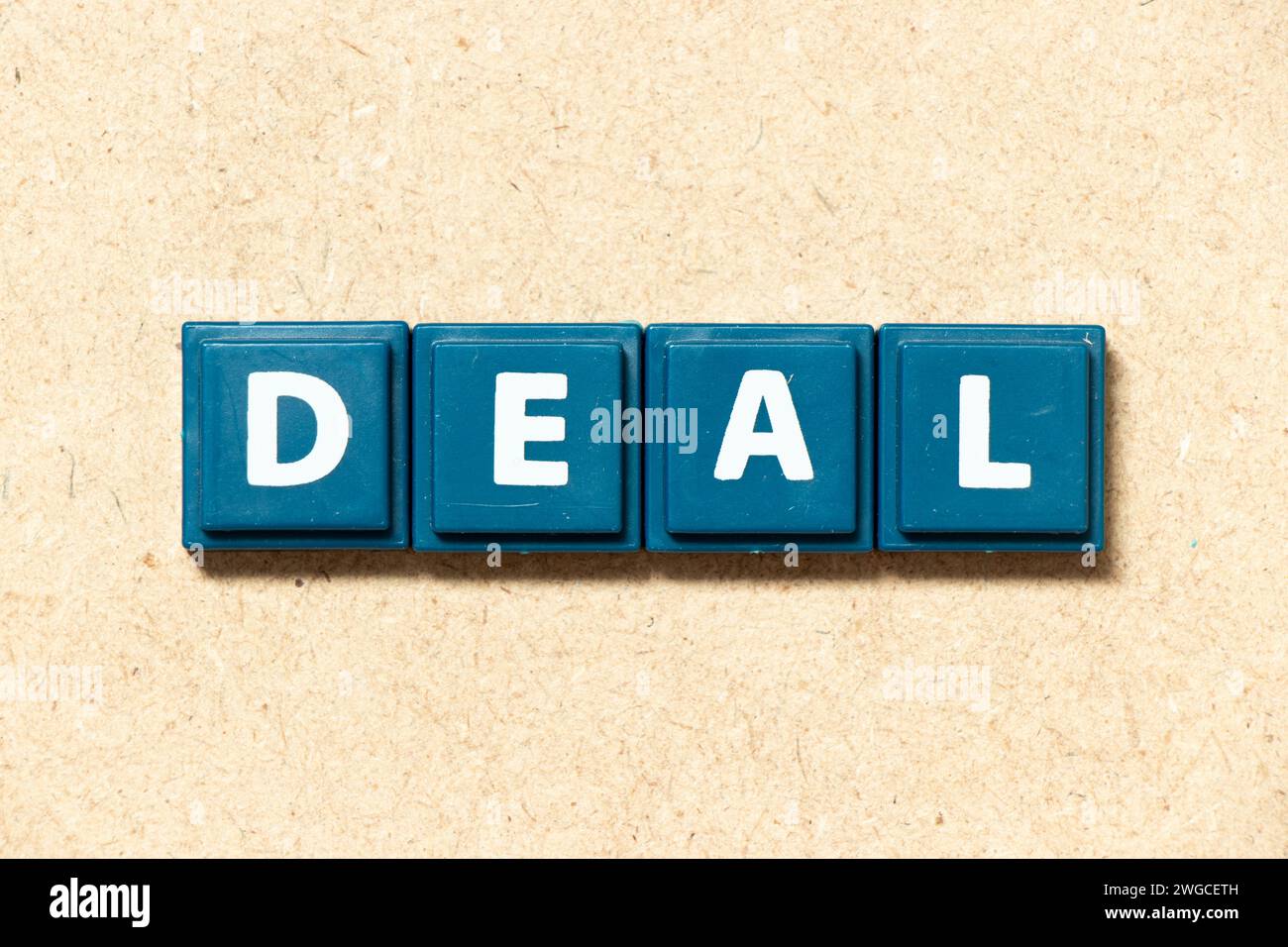 Tile alphabet letter in word deal on wood background Stock Photo - Alamy