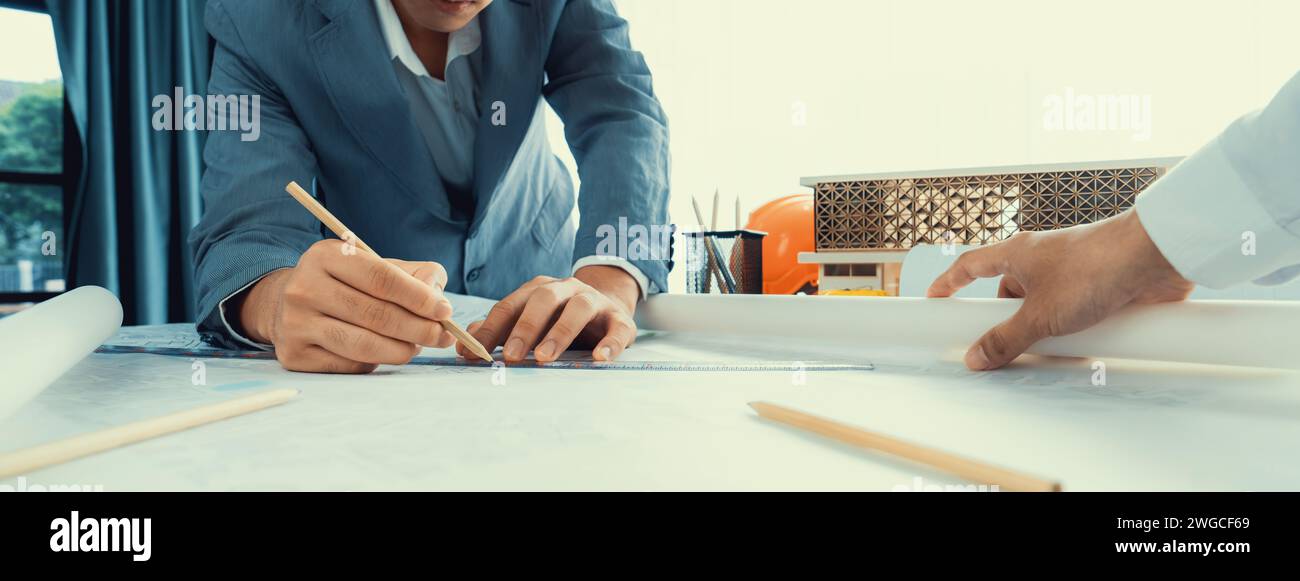 Worker, architect and engineer work on real estate construction project ...