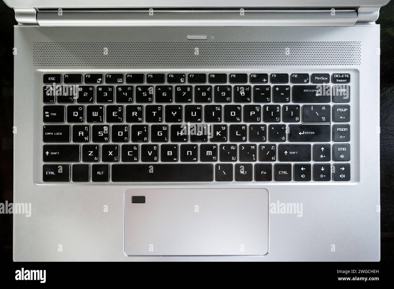 Flat Lay, Black keyboard Eng-Thai on gray modern laptop with touchpad ...