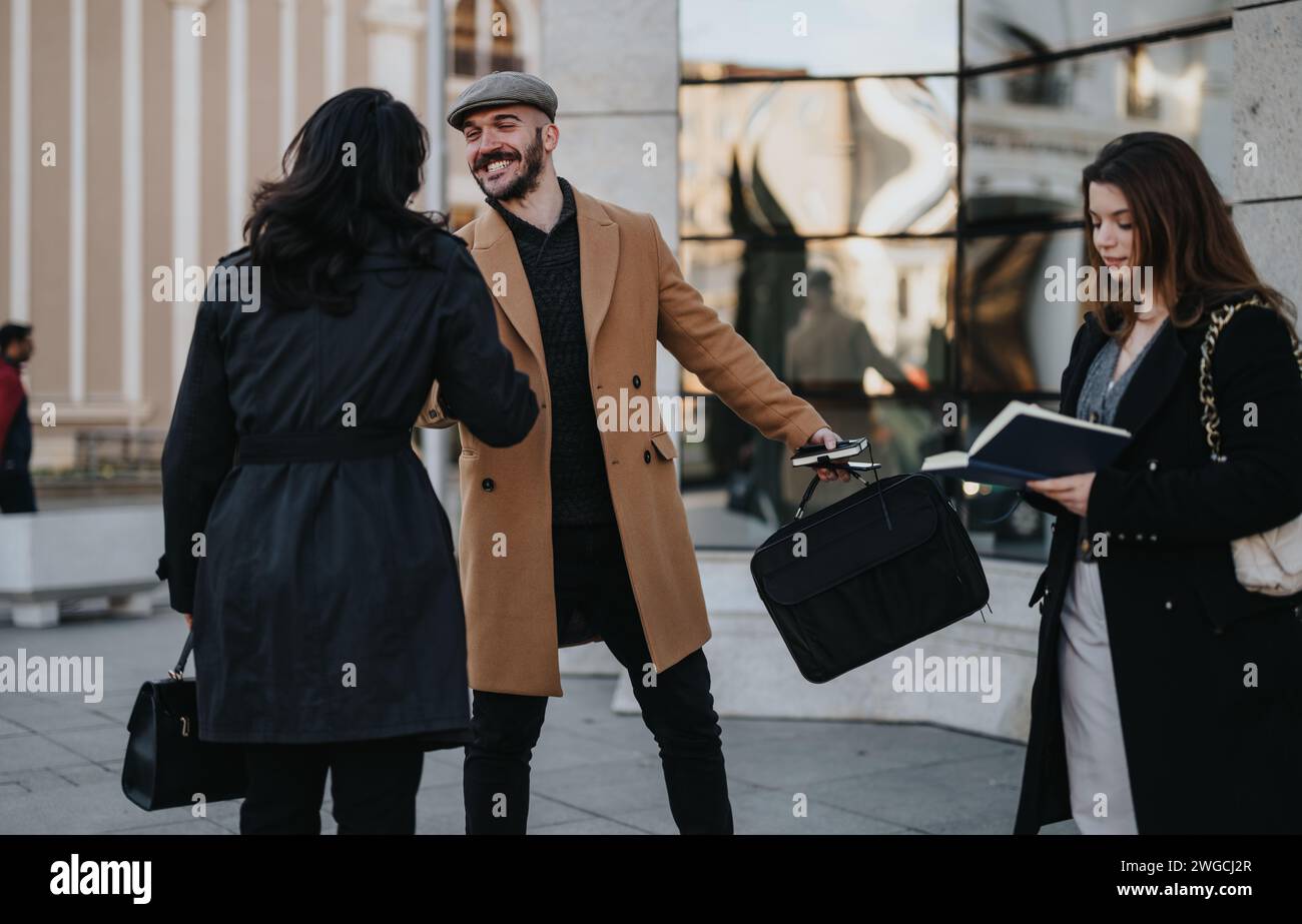Friendly meeting on the street with a man handing over a bag to a woman ...
