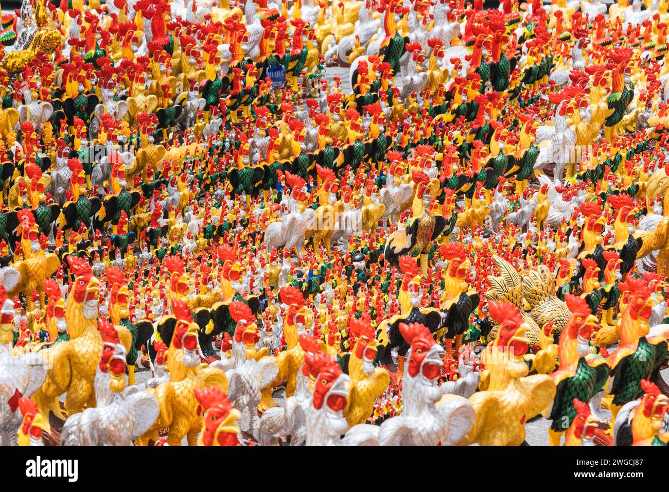 Many various size of chickens statue are worship and placed at the ...