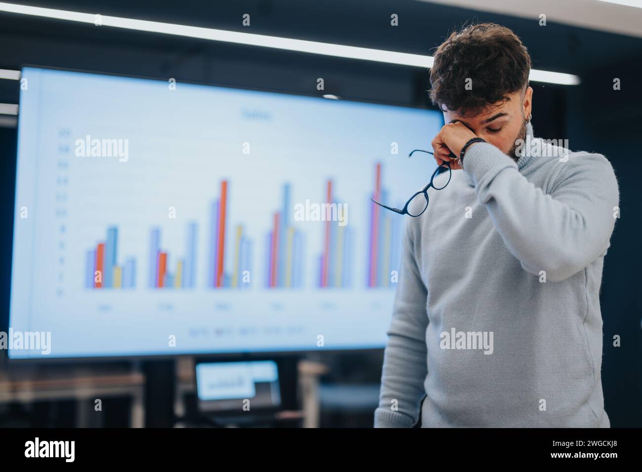 Exhausted, male employee rubbing his eyes after rough working day Stock ...