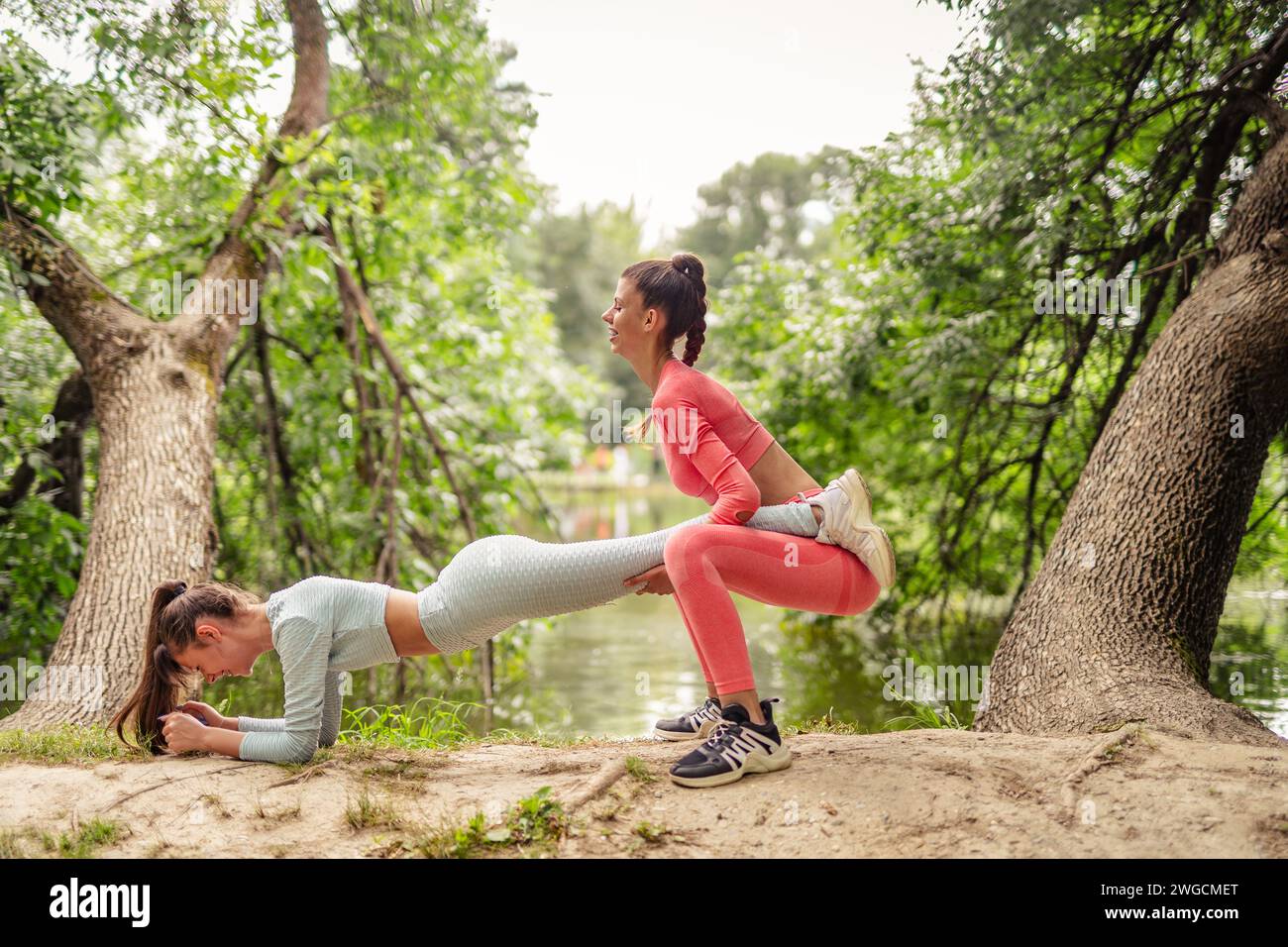 Attractive sportswomen engage in active outdoor workout routine ...