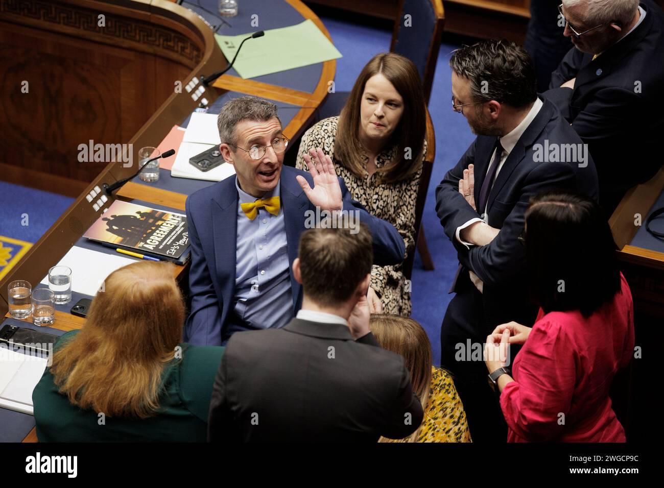 Alliance MLA Andrew Muir sitting with party colleagues (bow tie), who ...