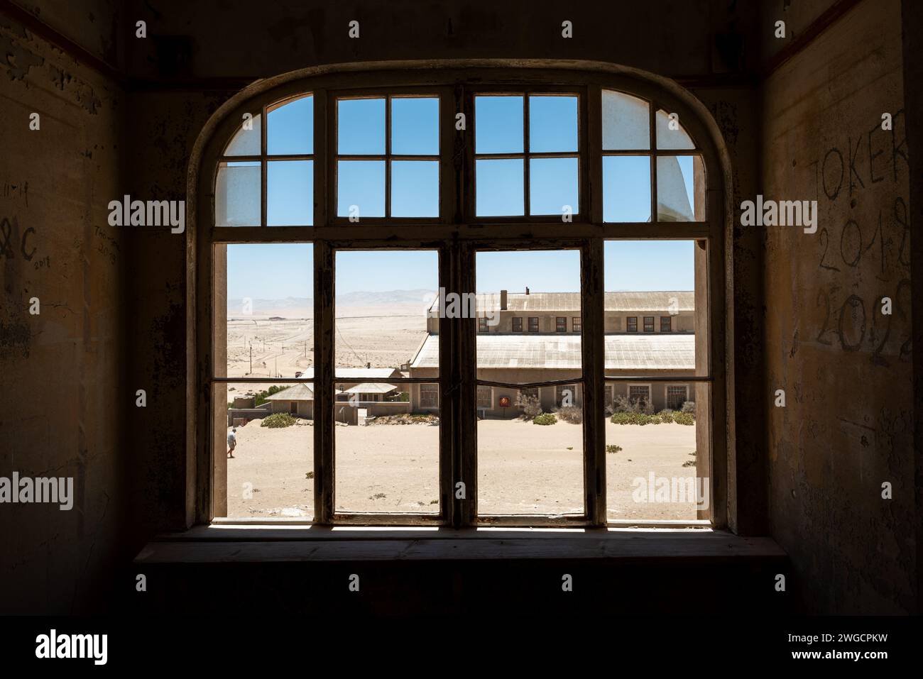 An aged, dilapidated room with a big window in an old desert town Stock ...