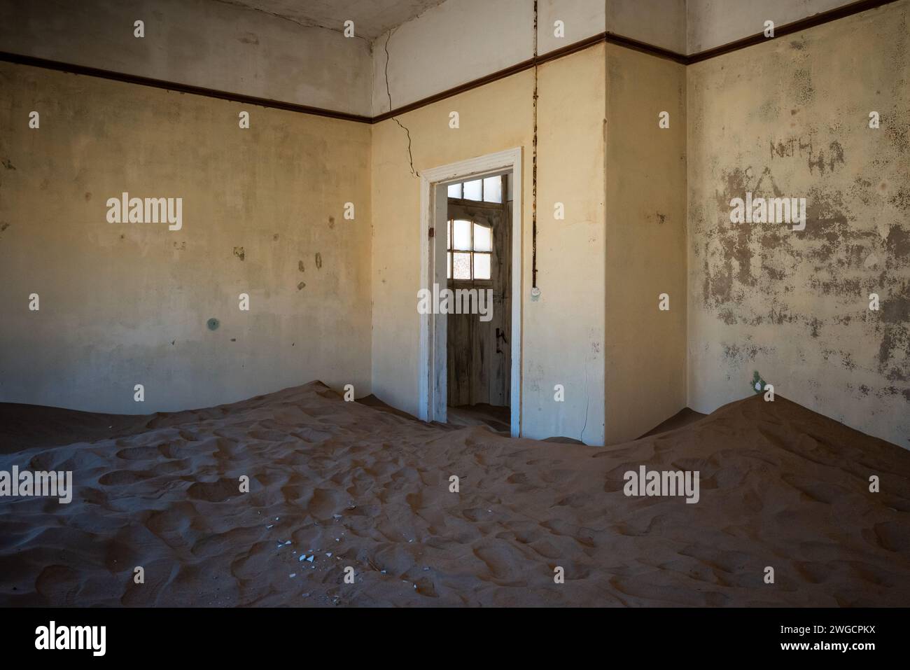 The inside of an abandoned building with damaged walls in an old desert ...