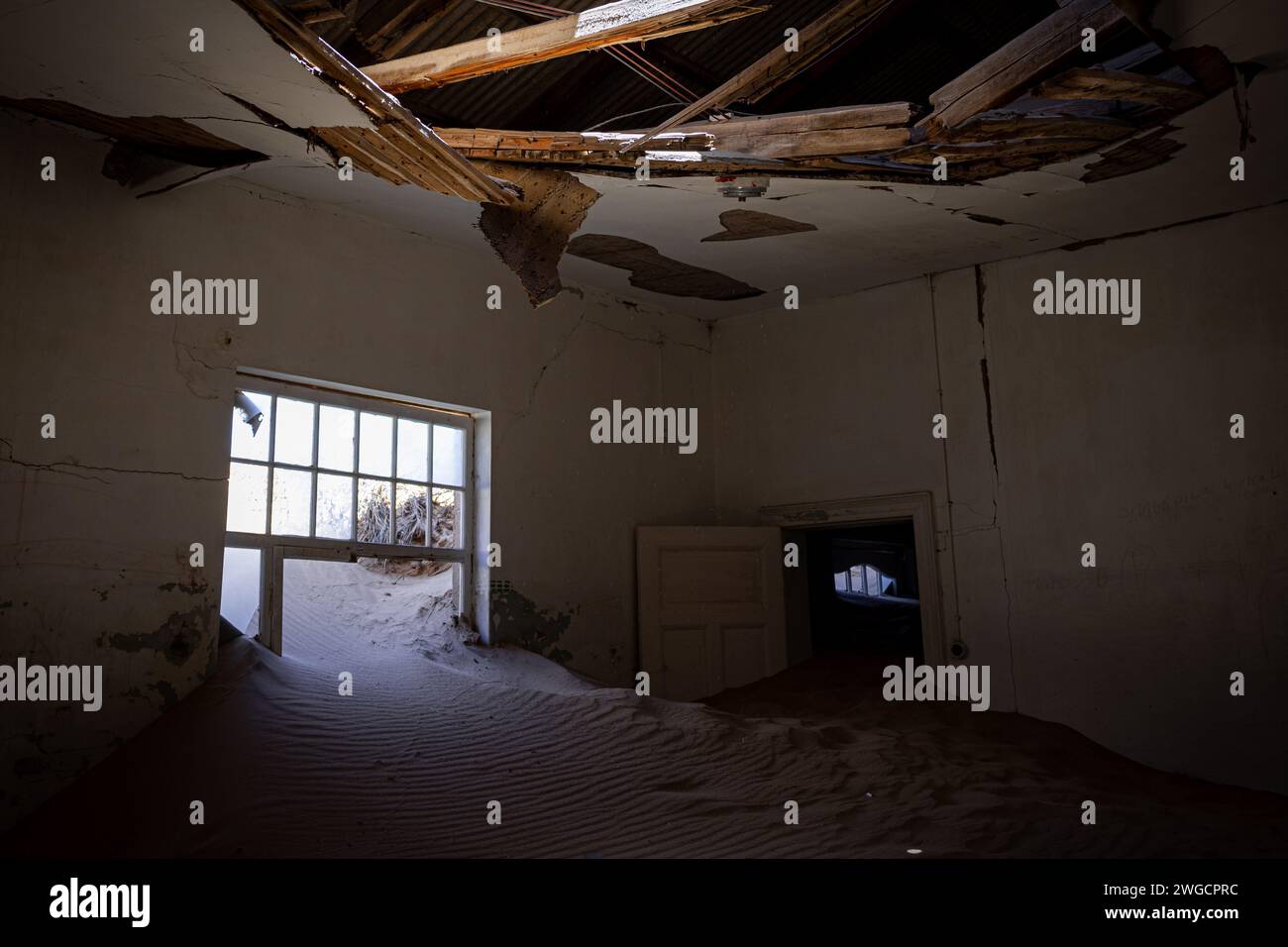 The inside of an abandoned building with damaged walls in an old desert ...