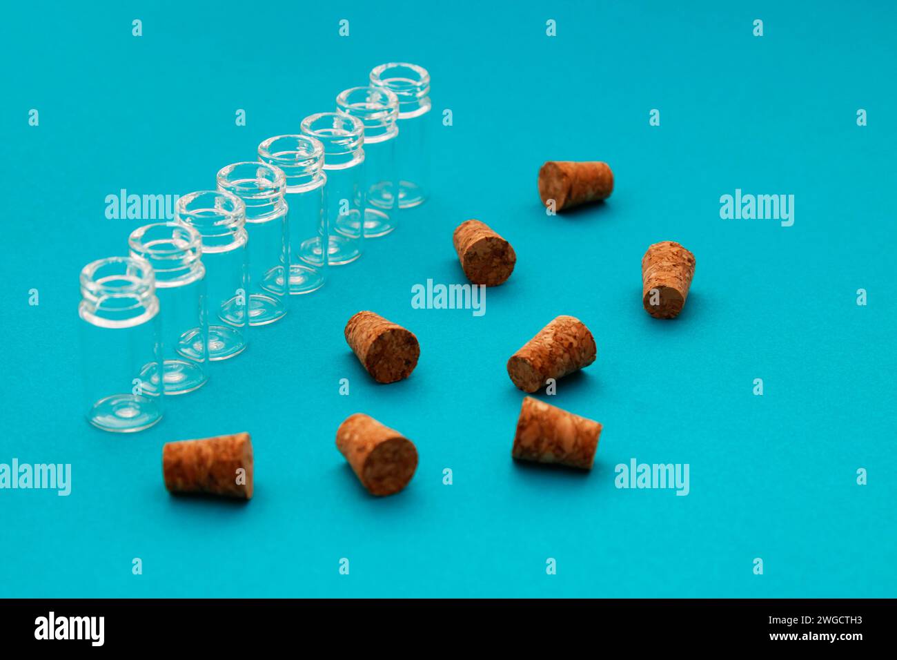Glass bottles arranged in a row and corks messy Stock Photo - Alamy