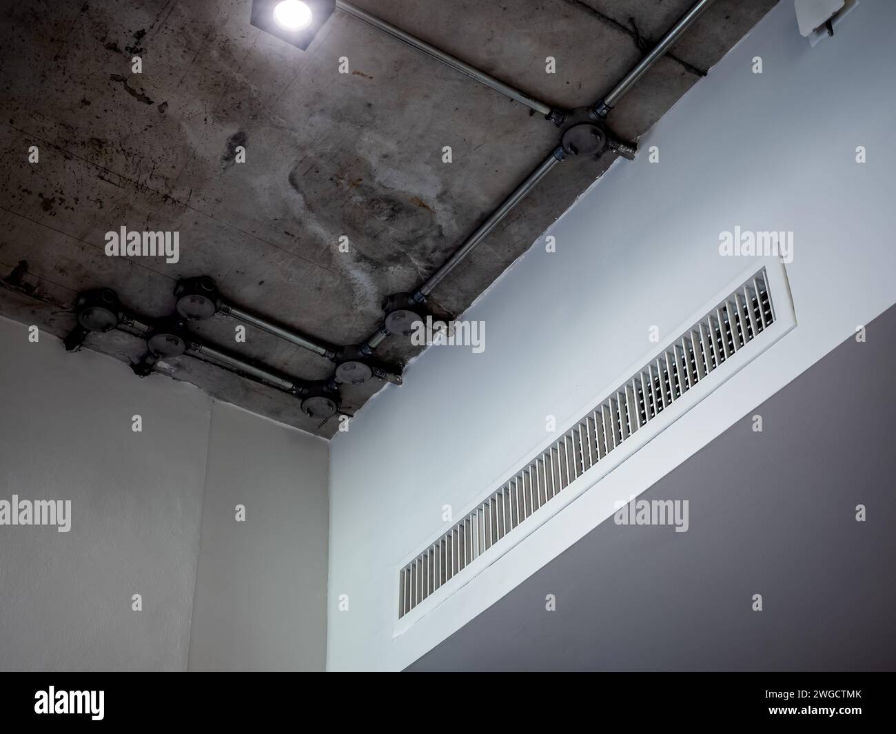 Air conditioning wall mounted ventilation system near concrete ceiling ...