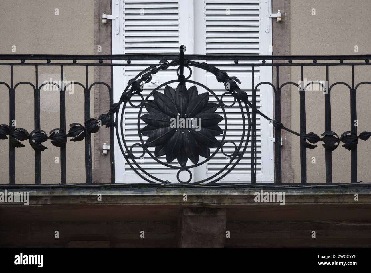 Antique house facade with wooden window shutters and a handcrafted ...