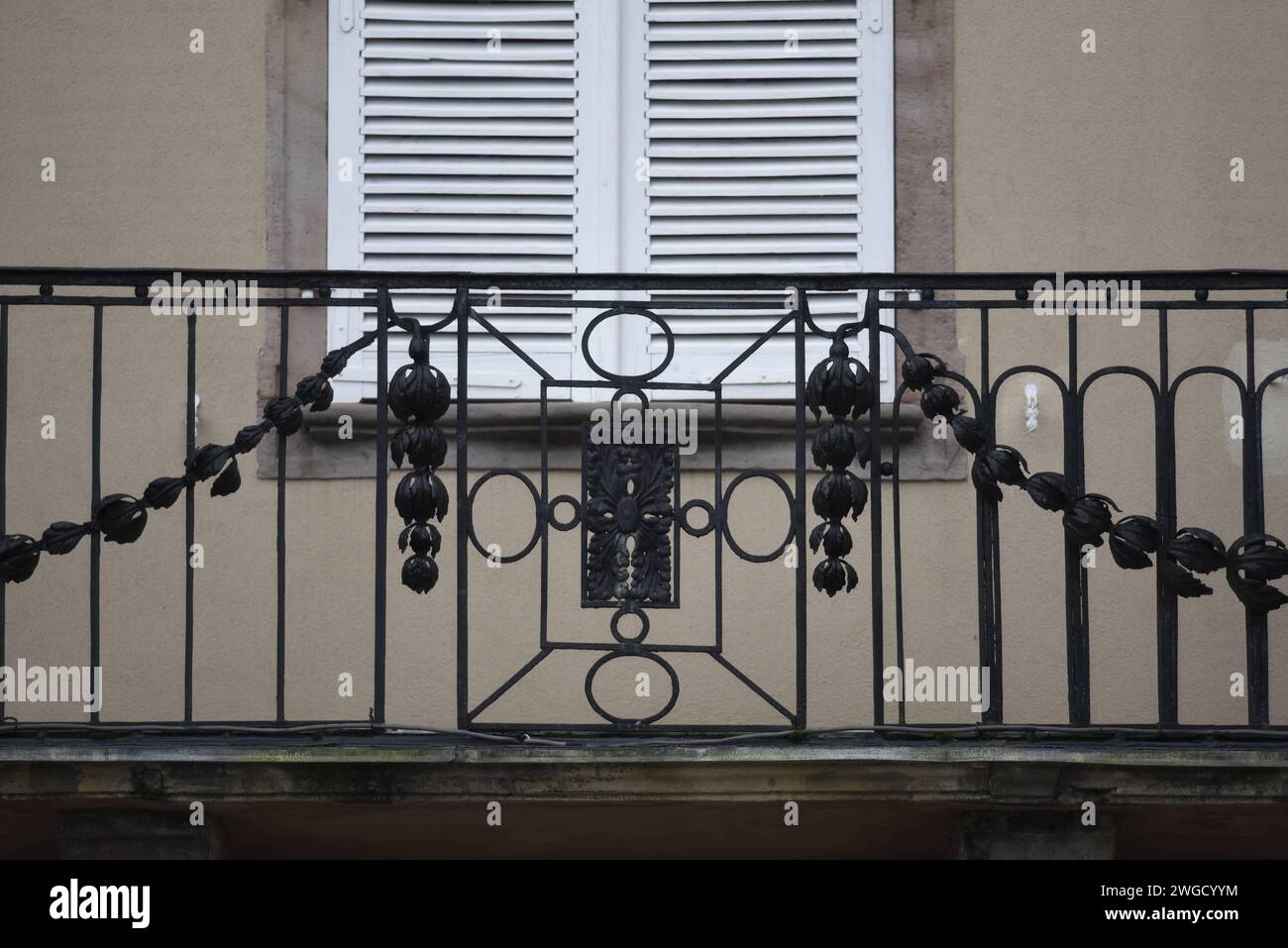 Antique house facade with wooden window shutters and a handcrafted ...
