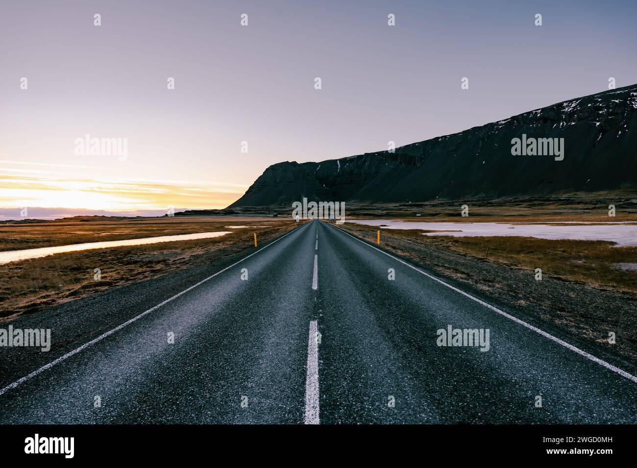 A Ring road number 1 in southern Iceland with mountains in the ...