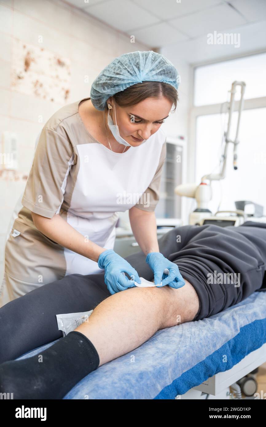 Medical woman worker doing wound treatment and removing stitches Stock ...