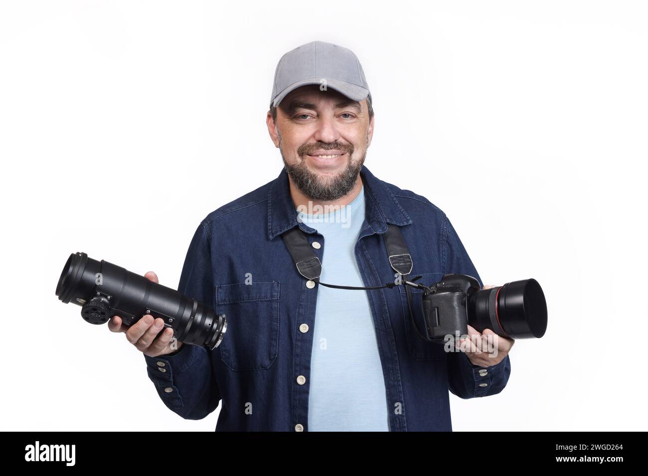 Male photographer posing with modern digital SLR camera and lens ...