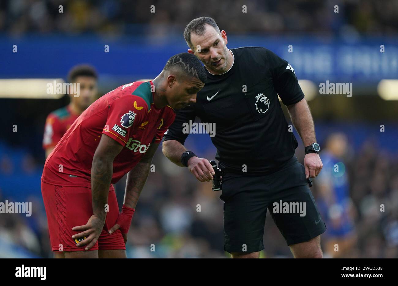 Referee Tim Robinson speaks with Wolverhampton Wanderers' Mario Lemina ...