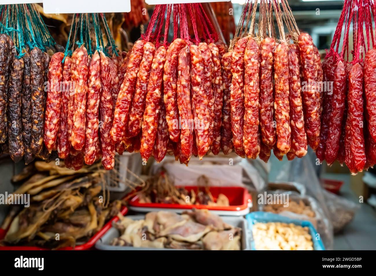 Dried sausage hanging by threads on a market stall on the street with ...