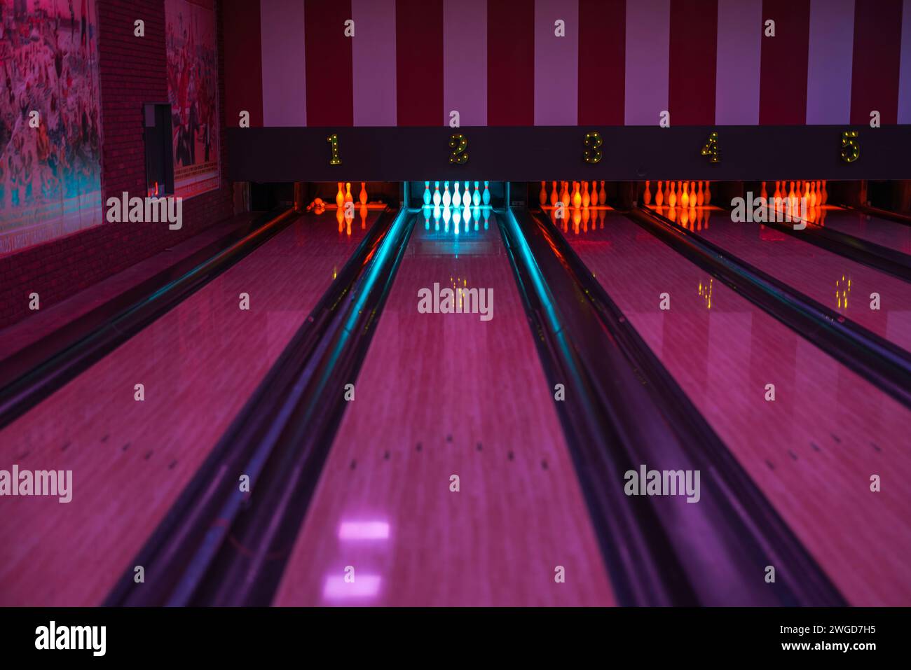 View of bowling alley interior with pins and five lanes in hall ...