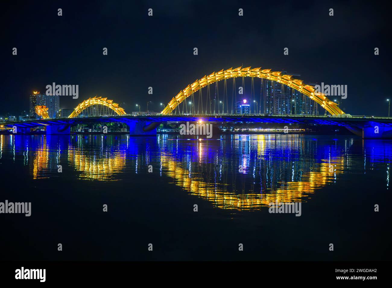 The Dragon Bridge at night with a reflection in the river,,Da Nang ...