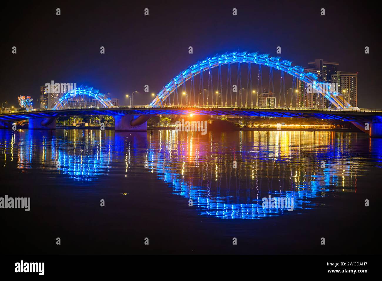 The Dragon Bridge at night with a reflection in the river,,Da Nang ...