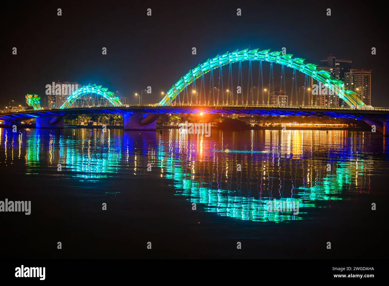 The Dragon Bridge at night with a reflection in the river,,Da Nang ...