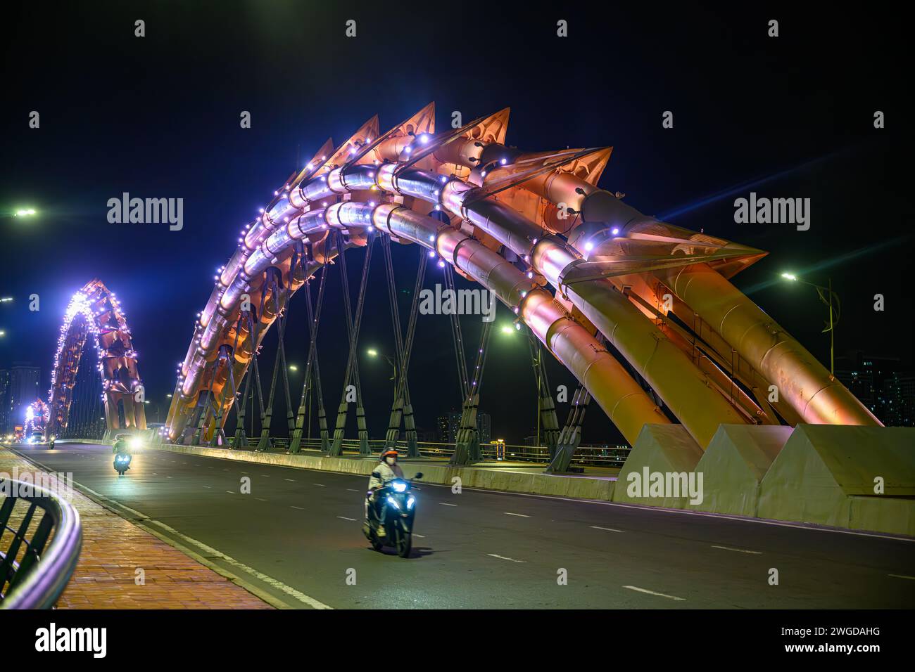 On the Dragon Bridge at night with a passing motorcycle,,Da Nang ...