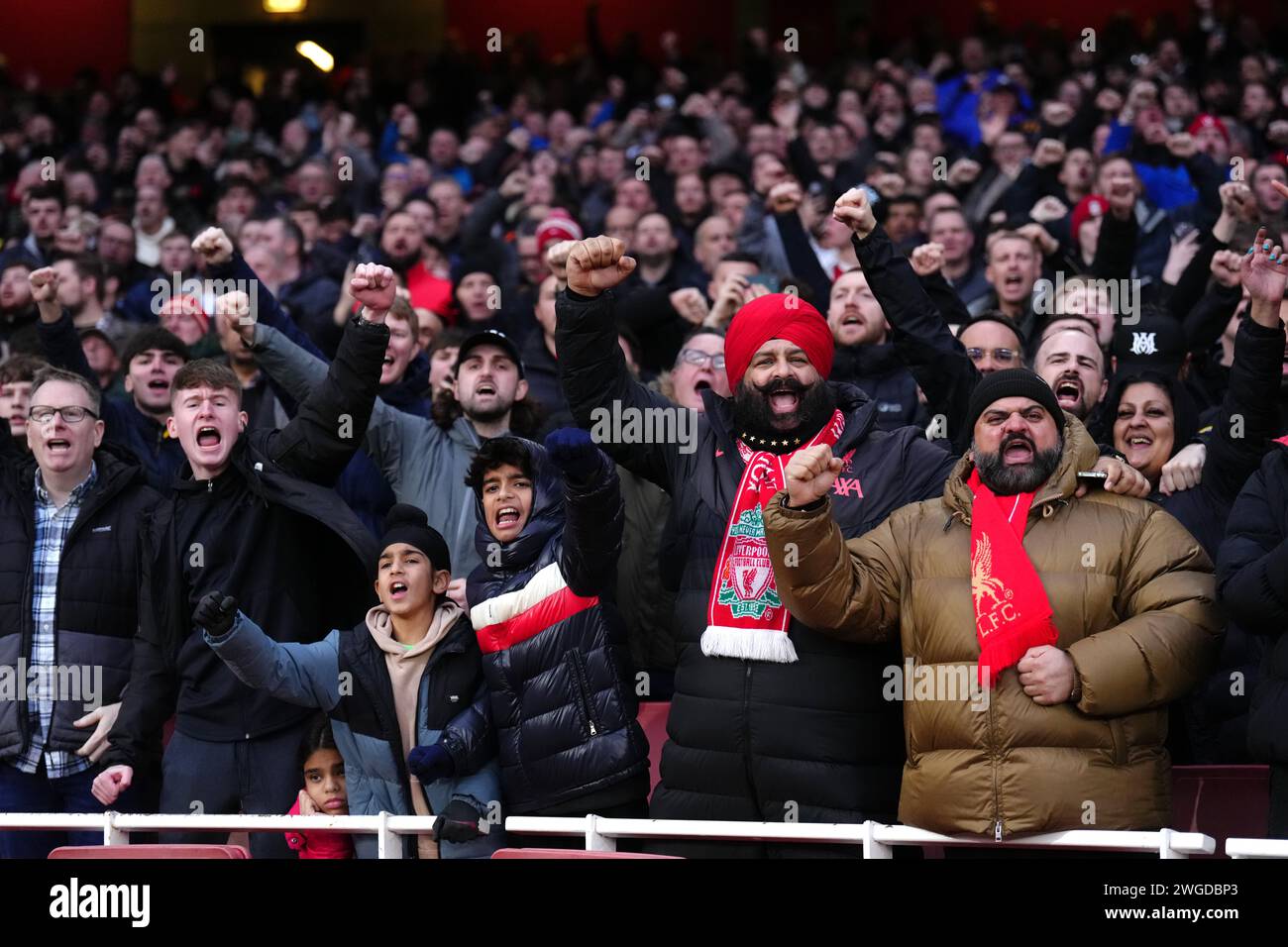 Liverpool fans cheer on their team ahead of the Premier League match at ...