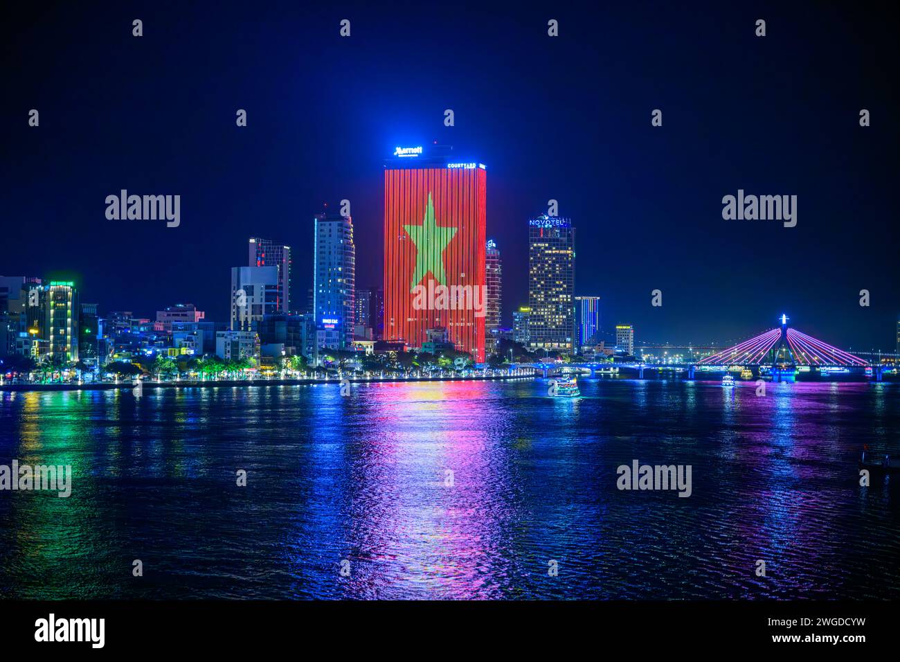 The River Han at night with an illuminated Vietnamese flag, Da Nang ...