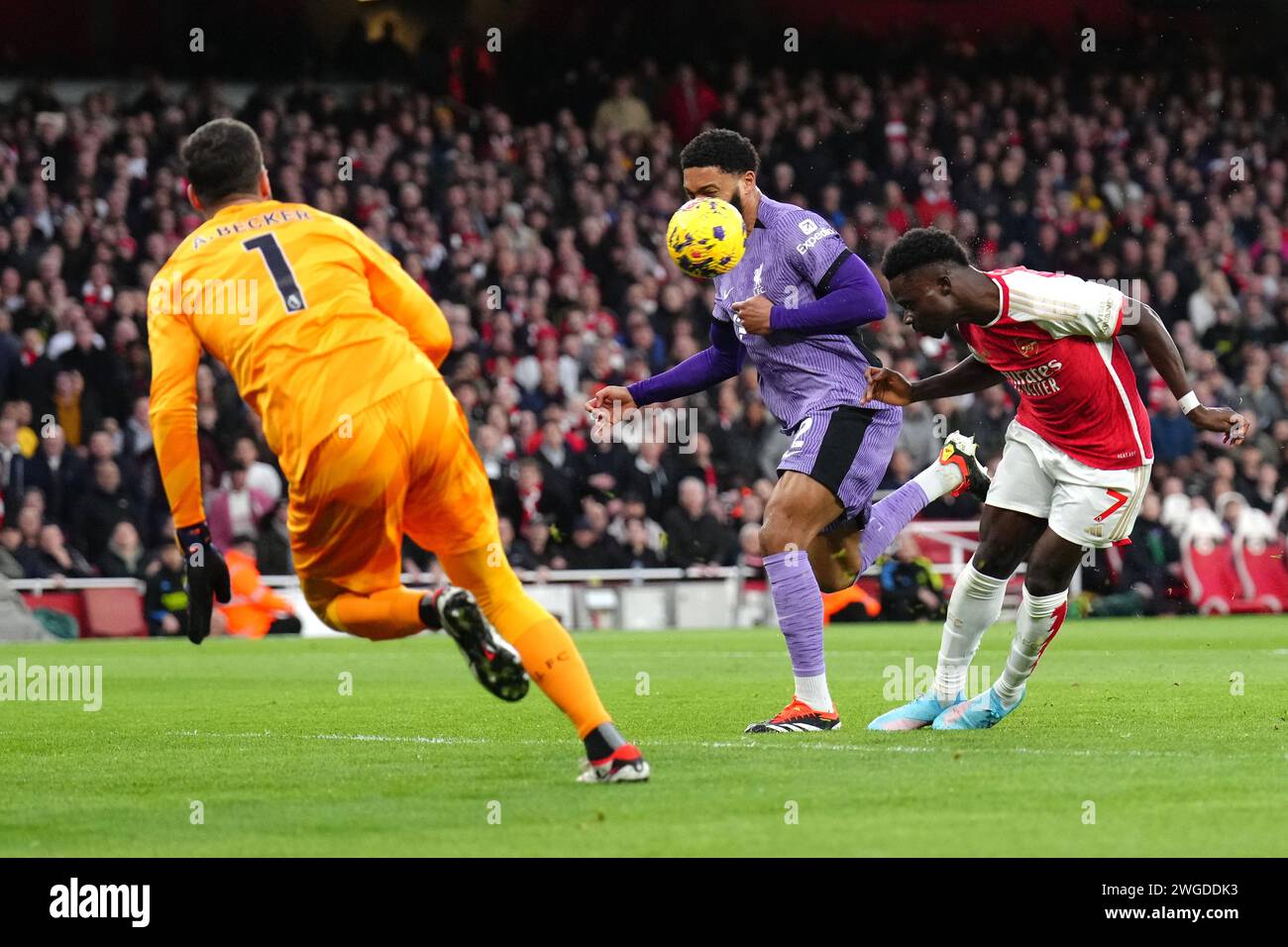 Arsenal's Bukayo Saka (right) attempts a headed shot towards goal ...