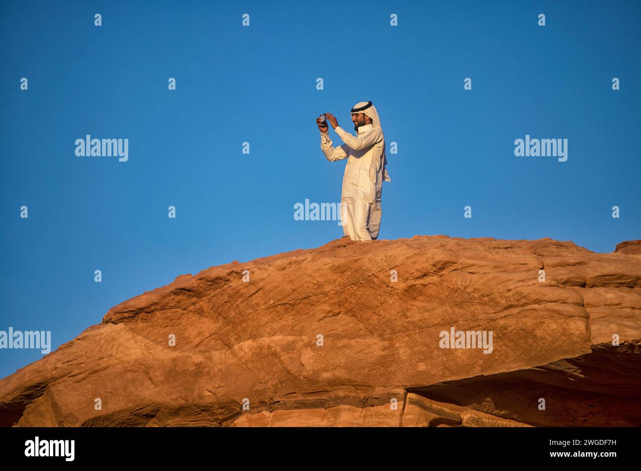 A male bedouin on top of a rock at Wadi Rum. Wādī Ramm, also Wādī al ...
