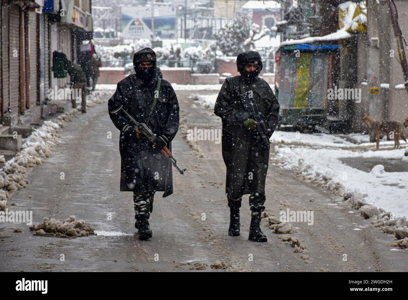 Indian paramilitary troopers patrol through the closed market during a ...