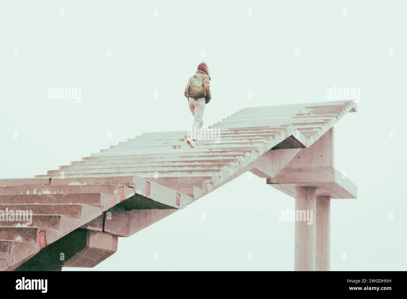 Woman walking on the stairs to nowhere. Girl climbing up stairs. Person ...