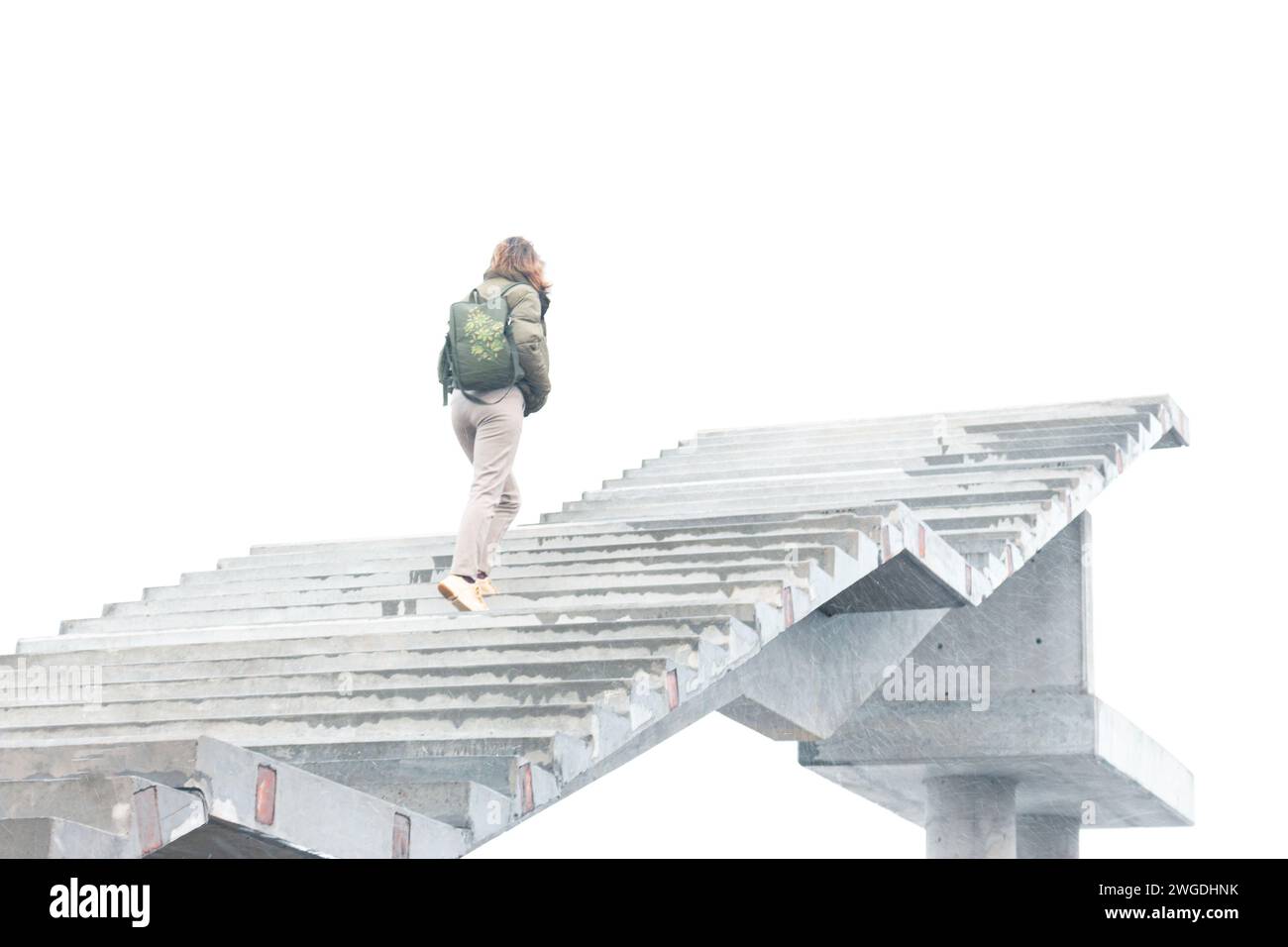 Woman walking on the stairs to nowhere. Girl climbing up stairs. Person ...