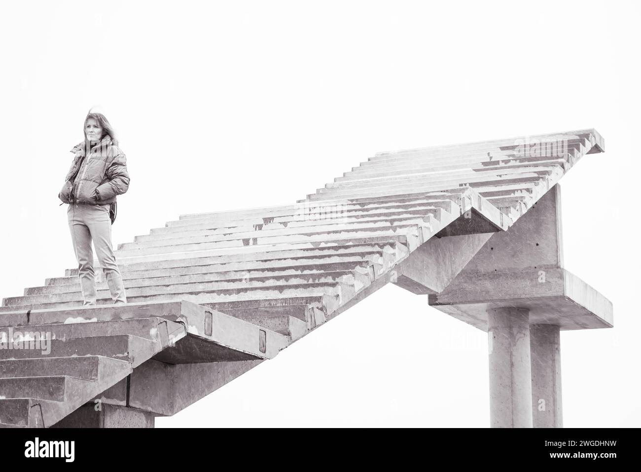 Woman walking on the stairs to nowhere. Girl climbing up stairs. Person ...