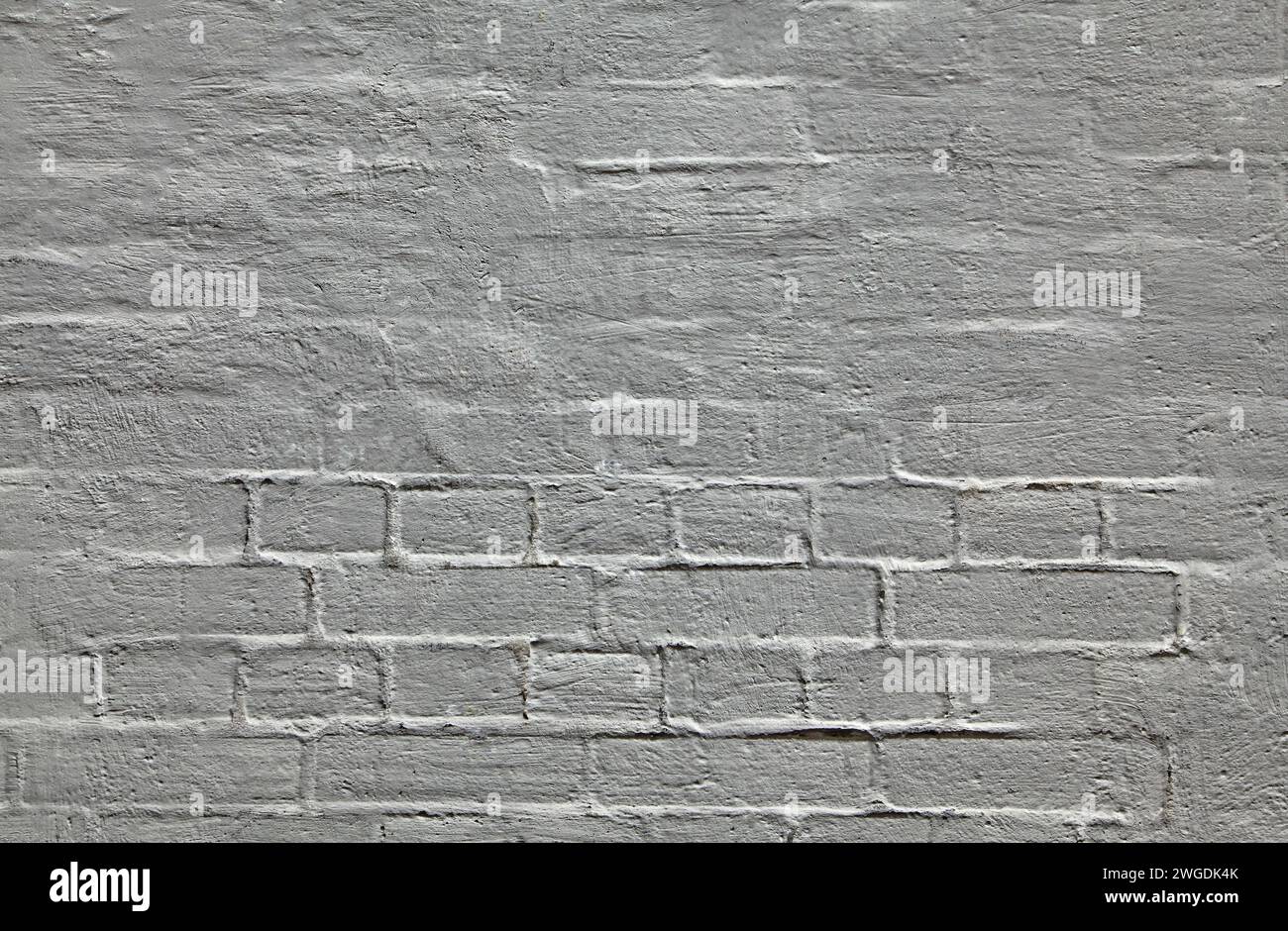 Grey building wall, painted with whiting. Wavy and bumpy surface. Brick ...