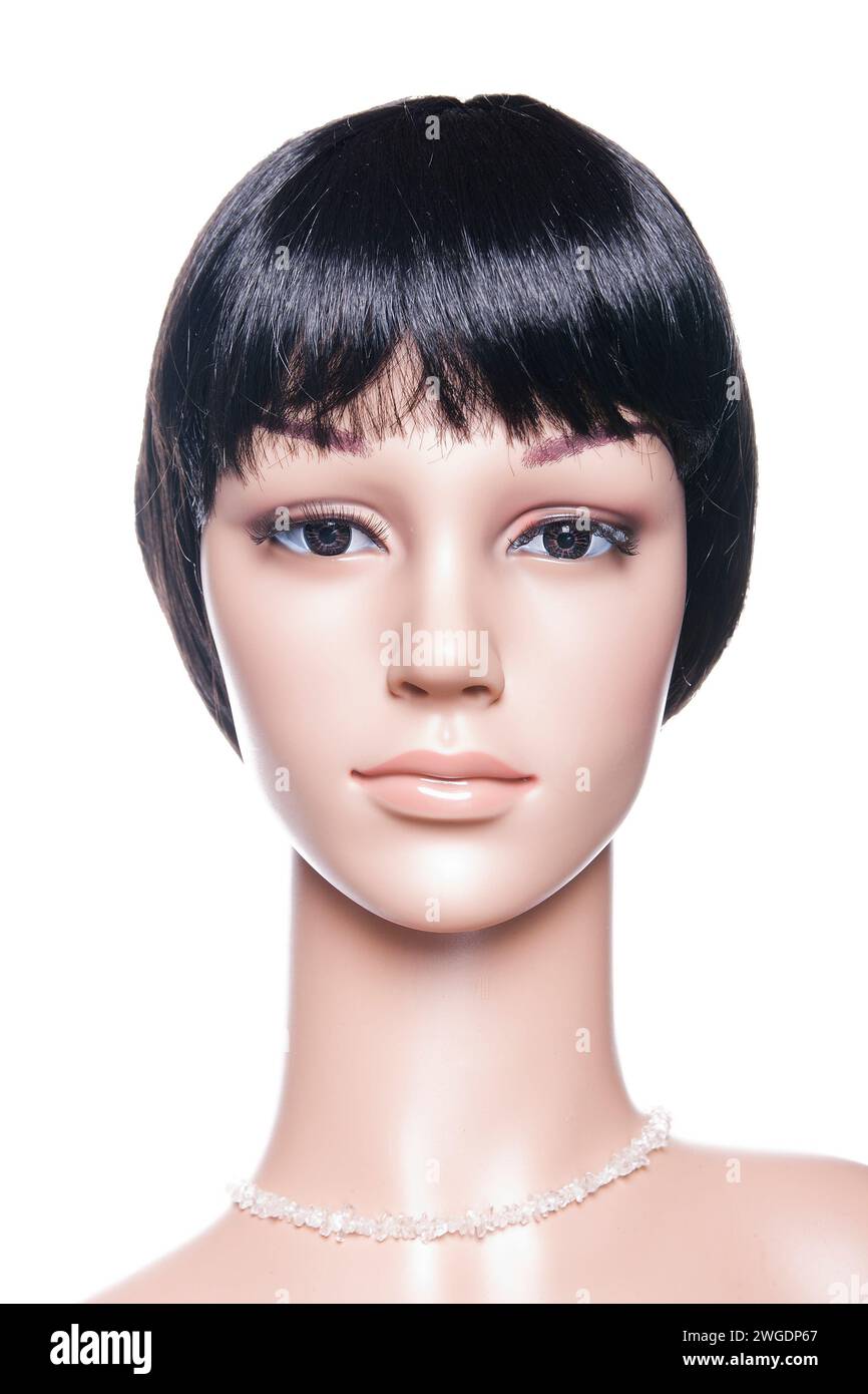 Plastic woman mannequin closeup with black hair posing on a white ...
