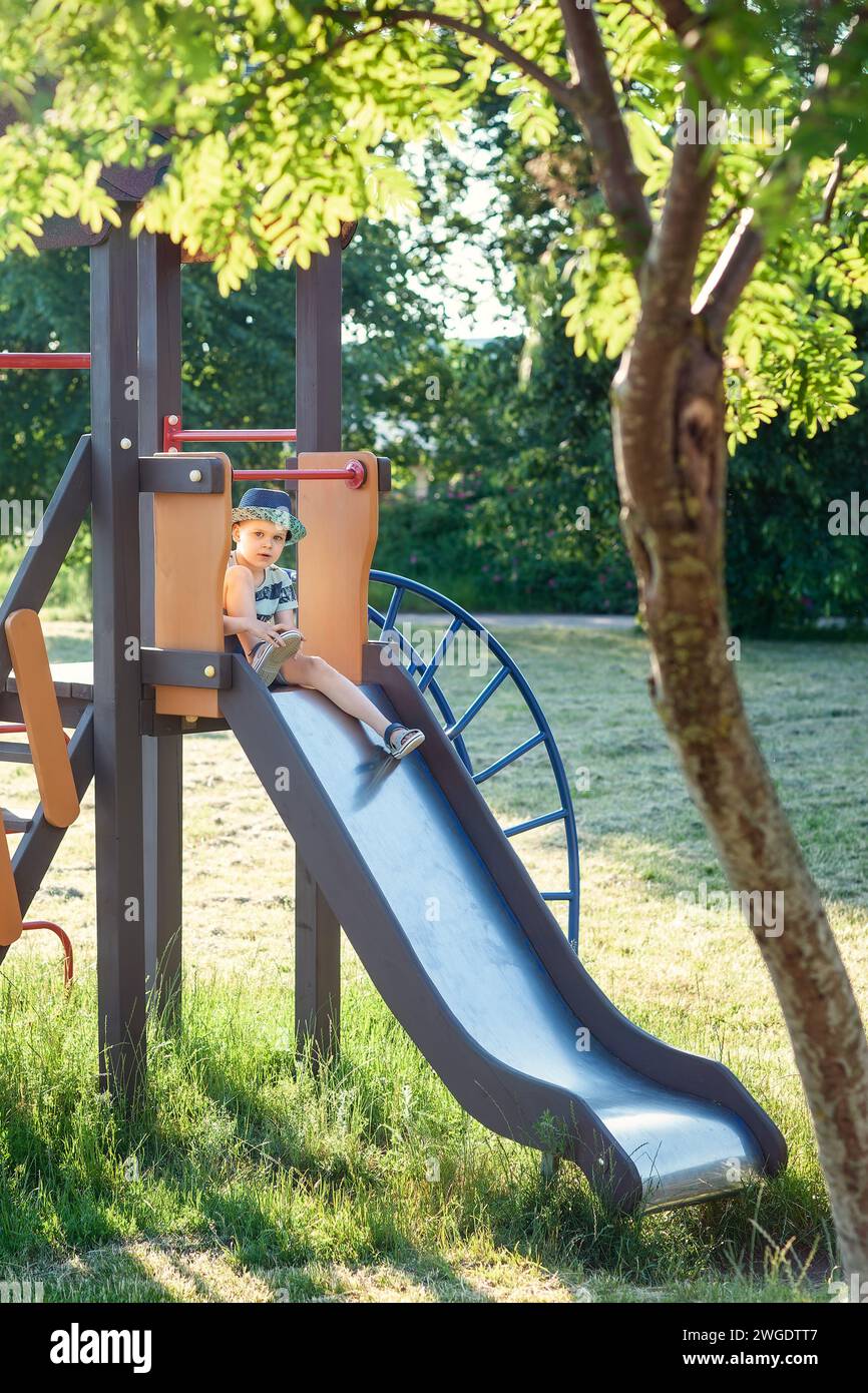 Happy little boy having fun on outdoor playground Stock Photo - Alamy