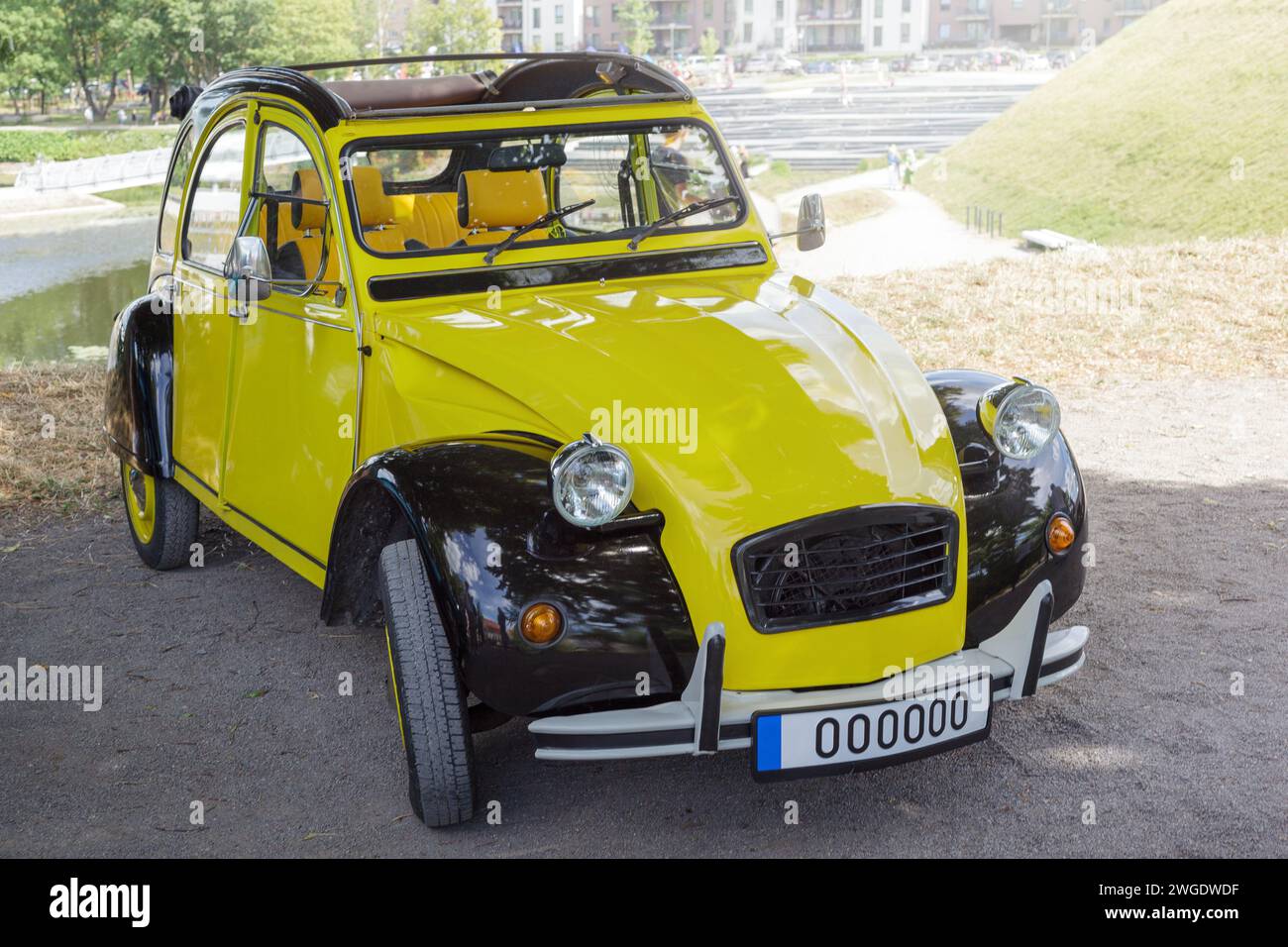 Typical French yellow small retro car in city festival Stock Photo - Alamy
