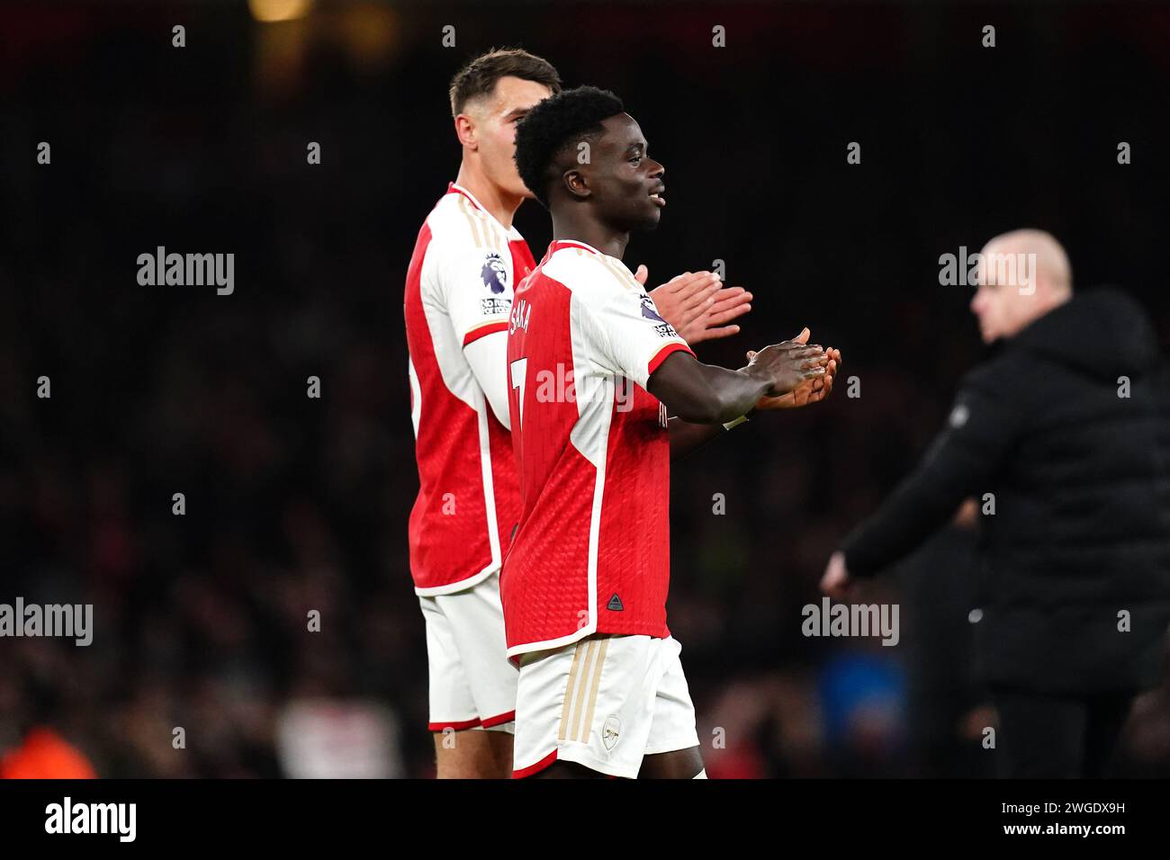 Arsenal's Bukayo Saka (front) applauds the fans after the final whistle ...