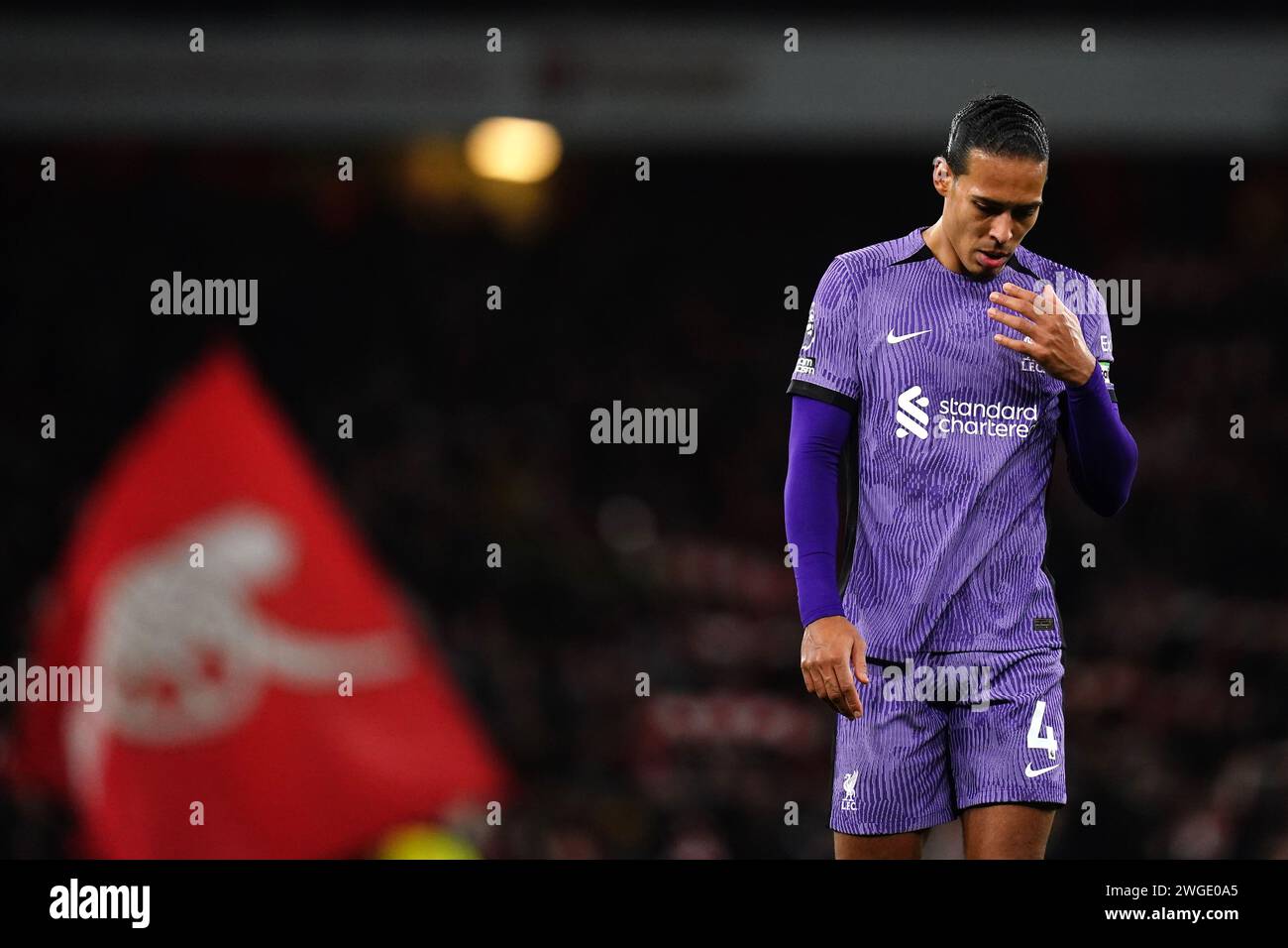 Liverpool's Virgil van Dijk looks dejected as a giant Arsenal flag is ...