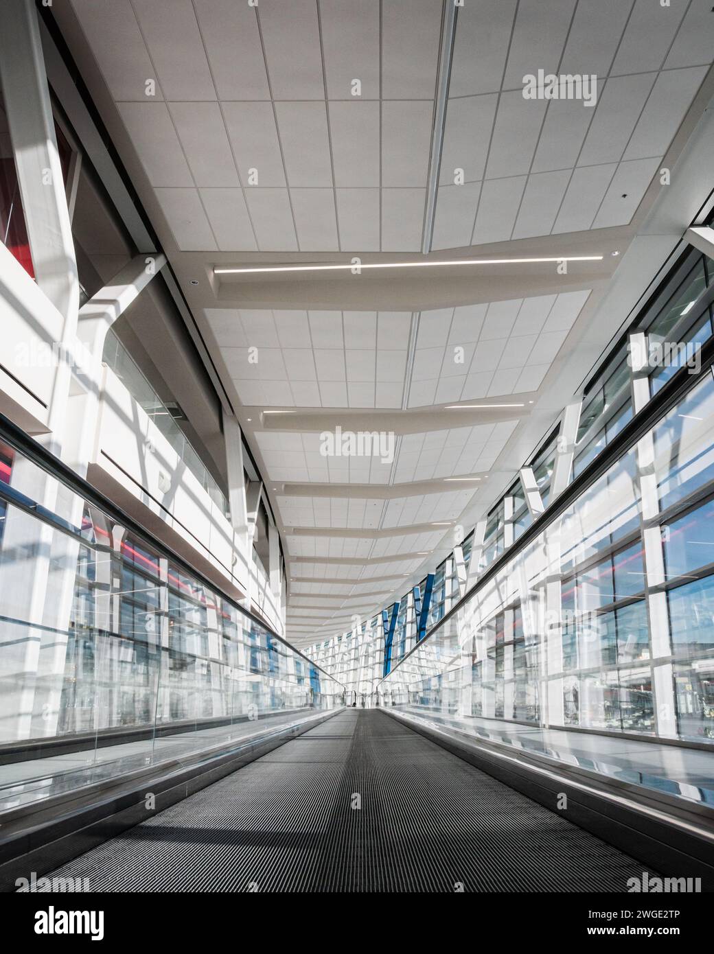 A path stretches far, leading to windows adjacent to a bench Stock ...