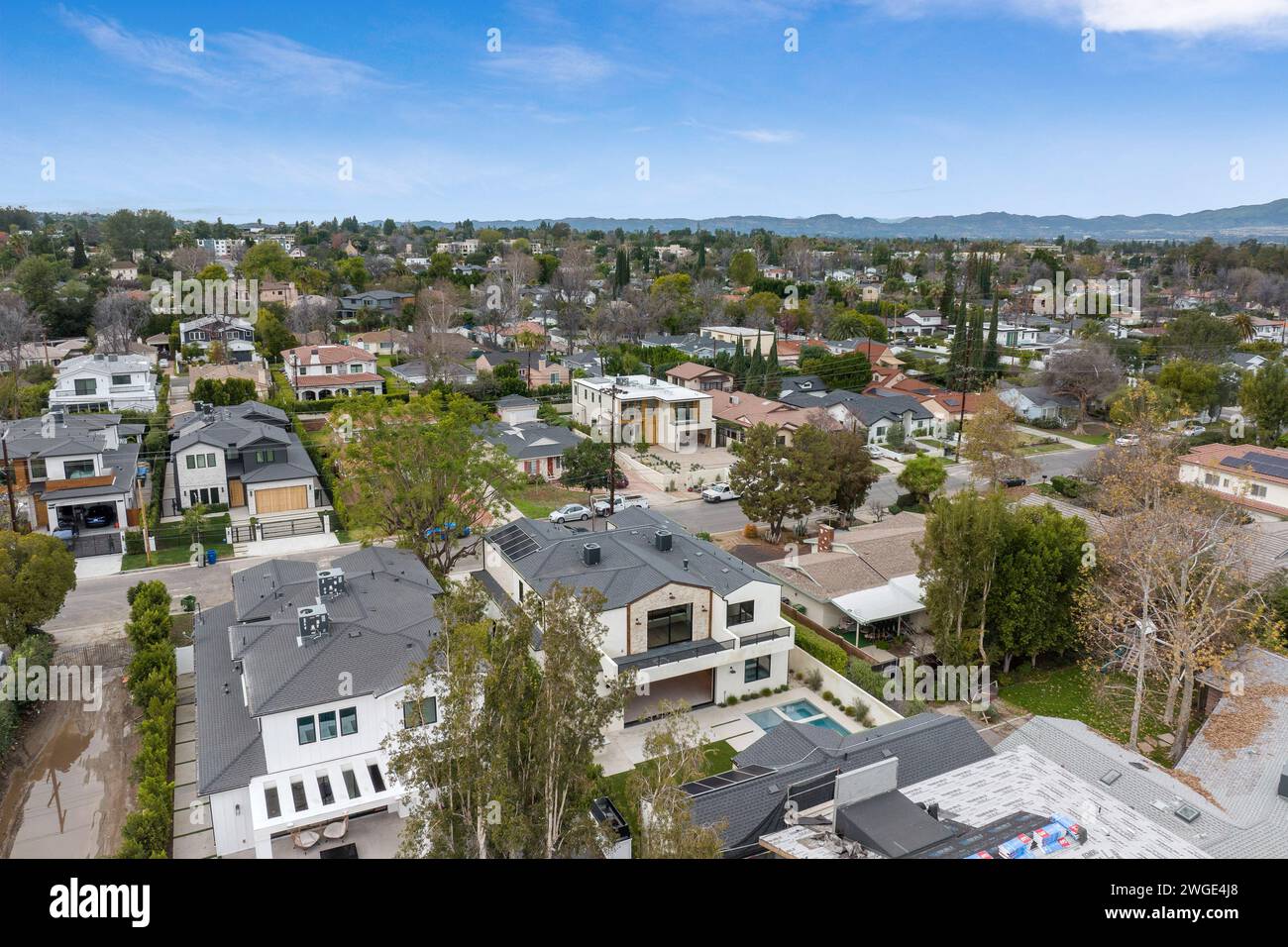 An aerial view of a suburban neighborhood with buildings and lush green ...