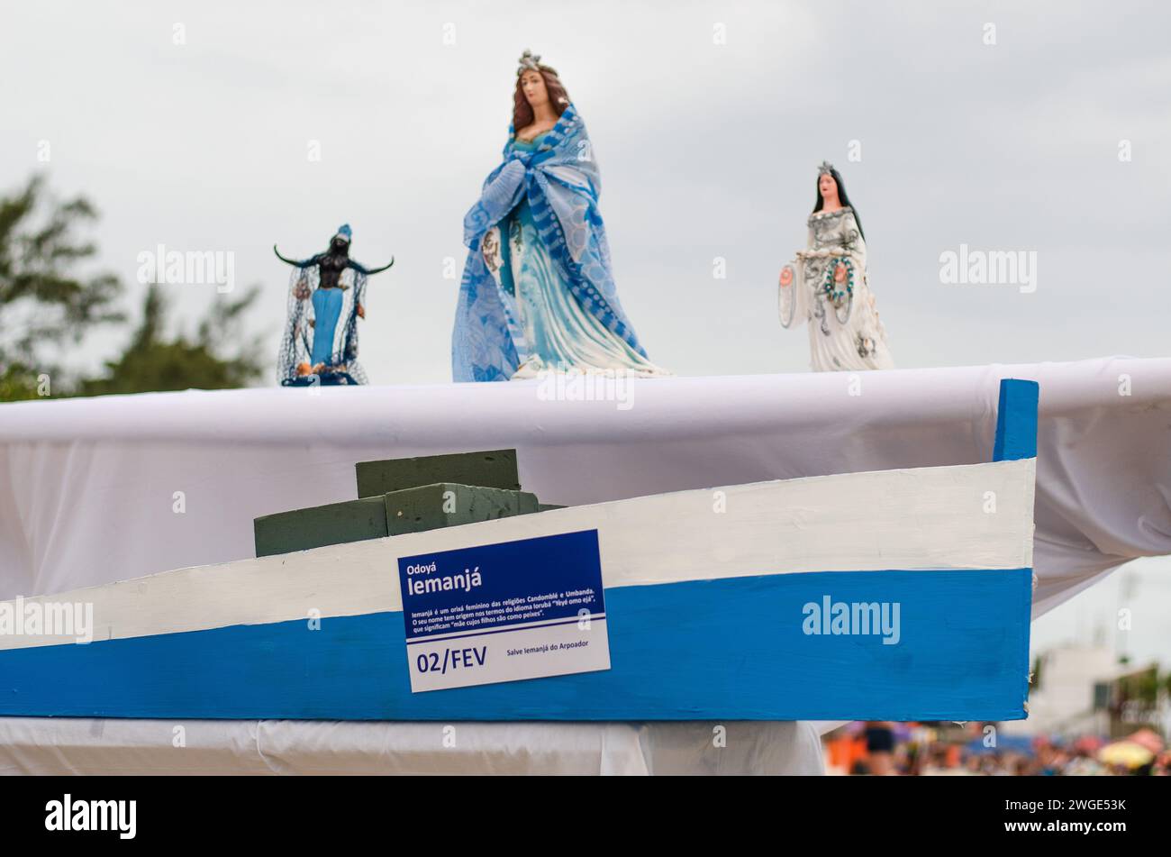 Three images of the orixá Iemanjá seen on a boat. On the boat is an ...