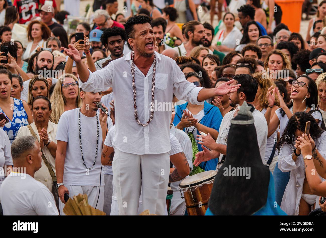 A man with a crowd behind him seen singing during Iemanjá's day. Every ...