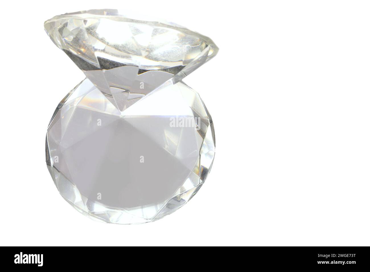 large brilliant cut diamond on white background and under the mirror ...
