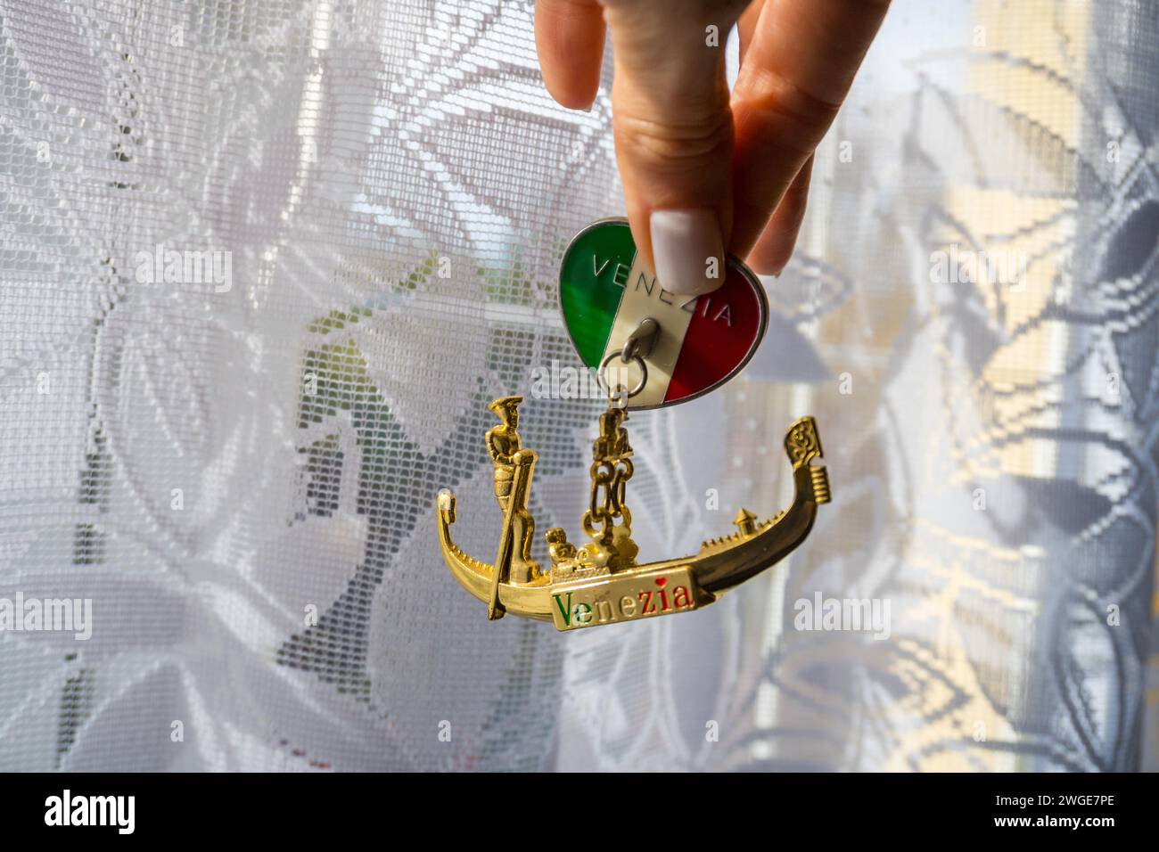 Gold figure of an man on a gondola. Traditional symbol of Italy on ...