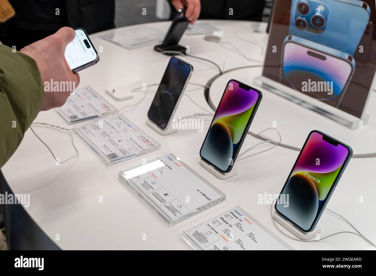 Apple iPhone 14 smartphones models at Apple store. Customers choosing ...