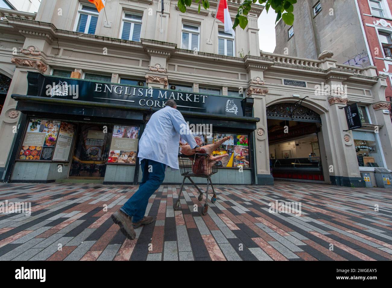 A butcher carrining meat into the English Market in Cork City centre ...