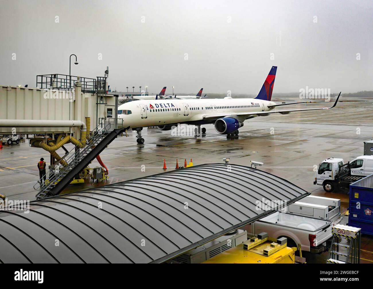 Taken from an indoor waiting area, a Delta airplane pulls up to a ...