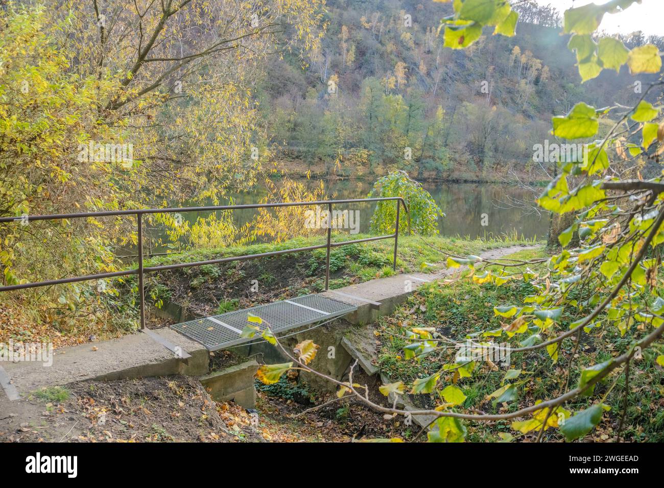 Small wooden iron pedestrian bridge to the river Berunka in Hlasna ...