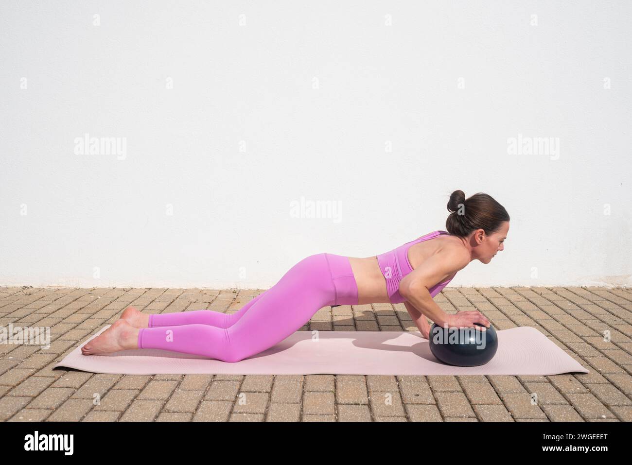 fit sporty woman doing pilates ball exercises outside. Press up ...